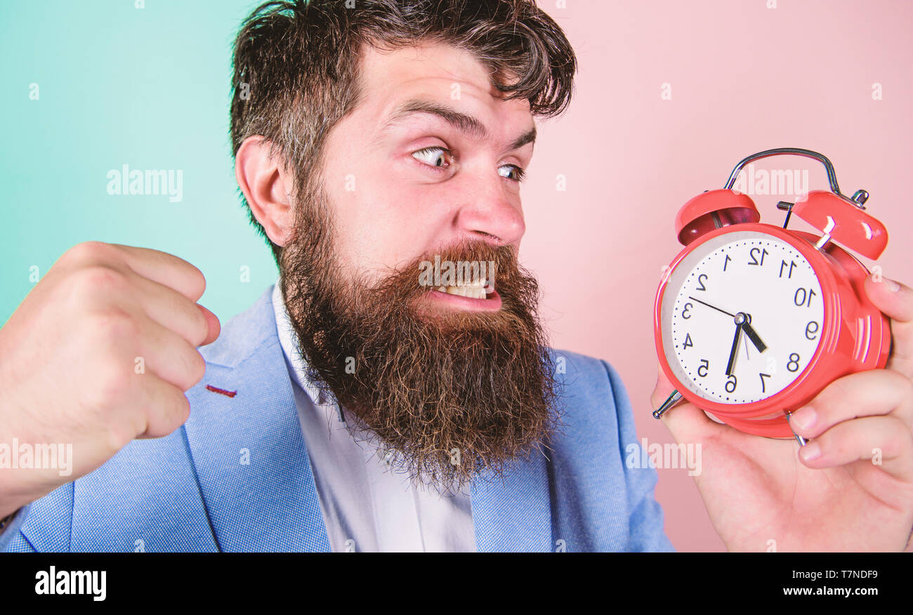 Time to work. Man bearded aggressive businessman hold clock. Stress ...