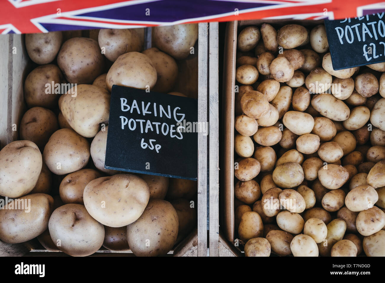 Close up of varieties of raw organic potatoes on sale in a wooden crate ...