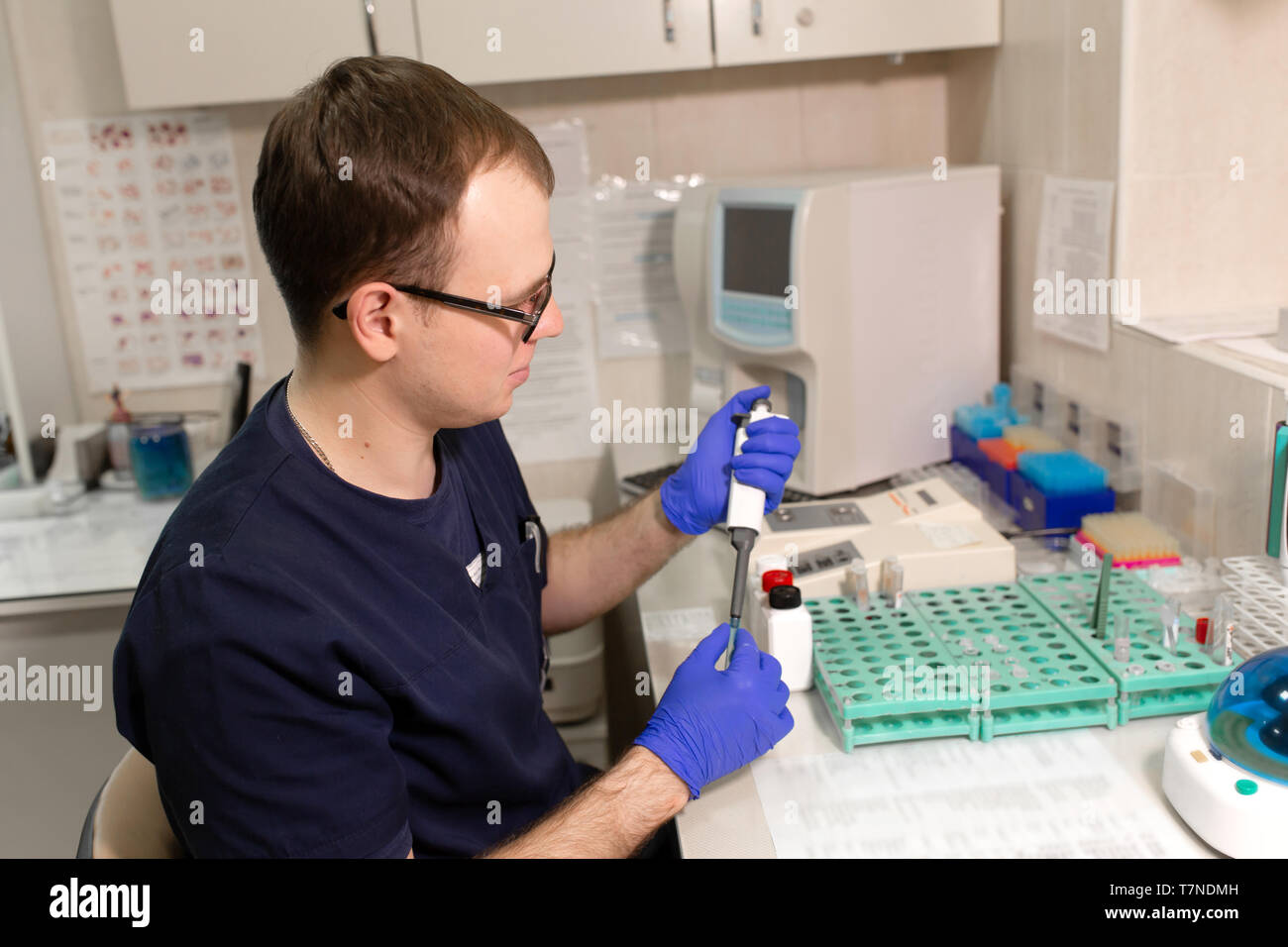 laboratory assistant analyzing a blood sample using micropipette Stock ...