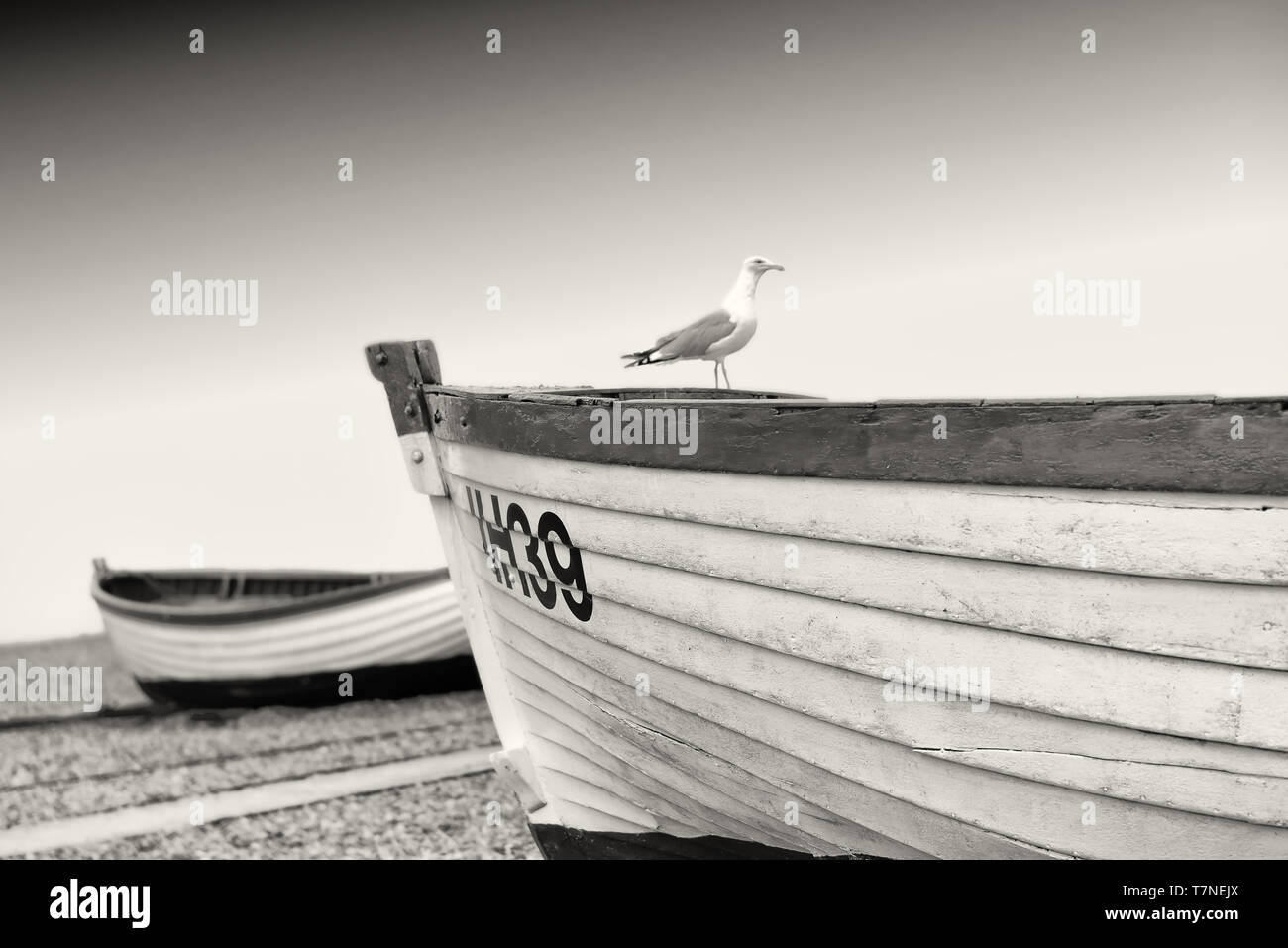 Close shot of fishing rowing boat with boat in background on Aldeburgh ...