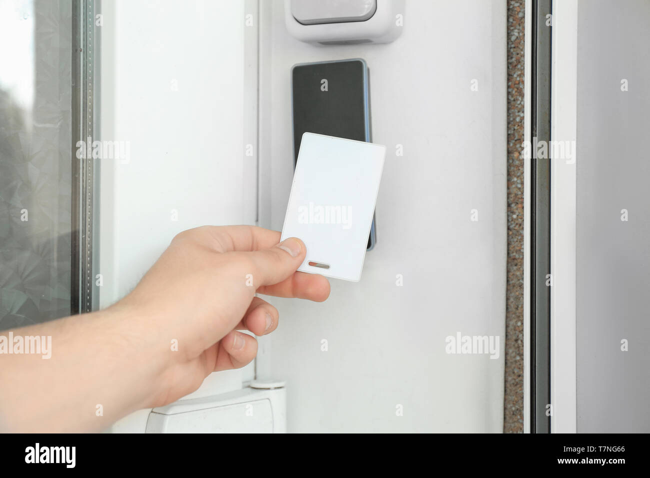Man opening door with security card outdoors Stock Photo - Alamy