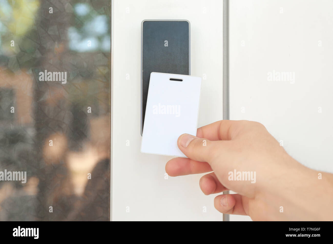 Man opening door with security card outdoors Stock Photo - Alamy
