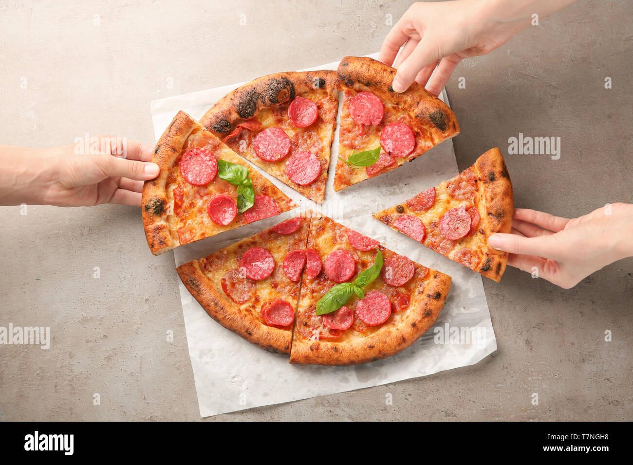 Hands taking pizza slices hi-res stock photography and images - Alamy