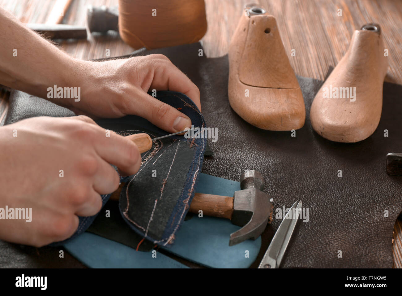 Shoemaker working with leather at factory Stock Photo - Alamy