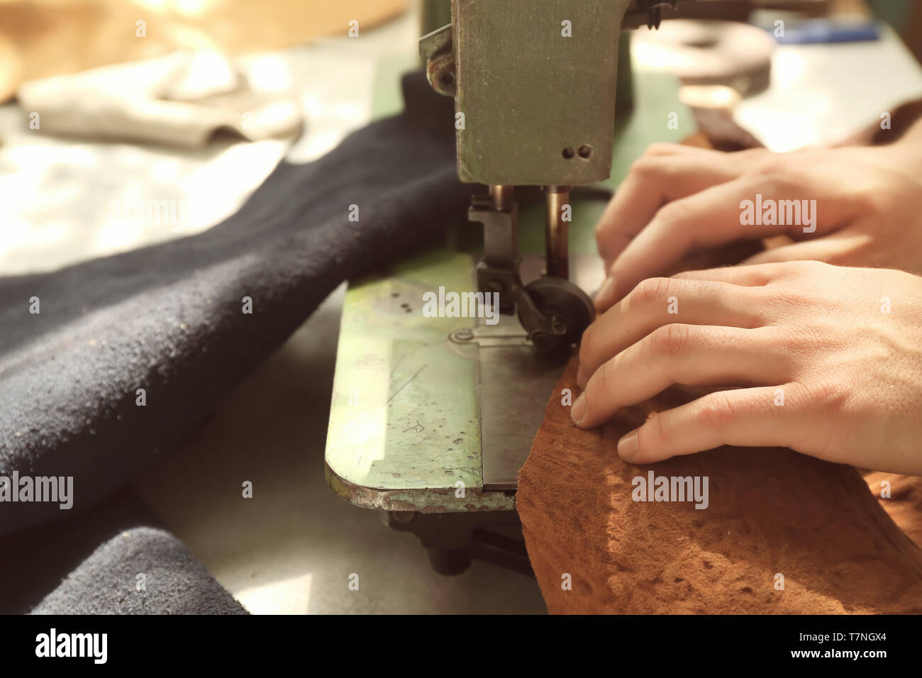 Man using sewing machine in leather workshop Stock Photo - Alamy