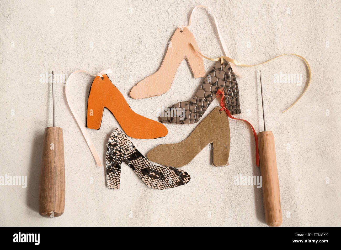 Samples of leather in shape of shoe with craft tools on light ...