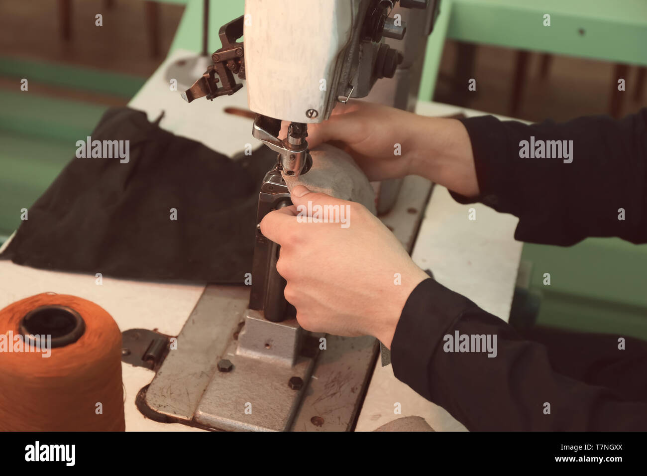 Man using sewing machine in leather workshop Stock Photo - Alamy