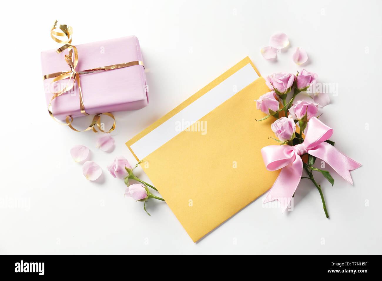 Open mail envelope with flowers and gift box on white background Stock ...