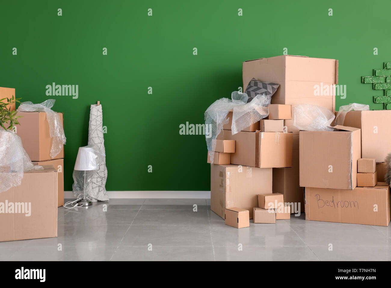 Carton boxes and interior items in room. Moving house concept Stock ...