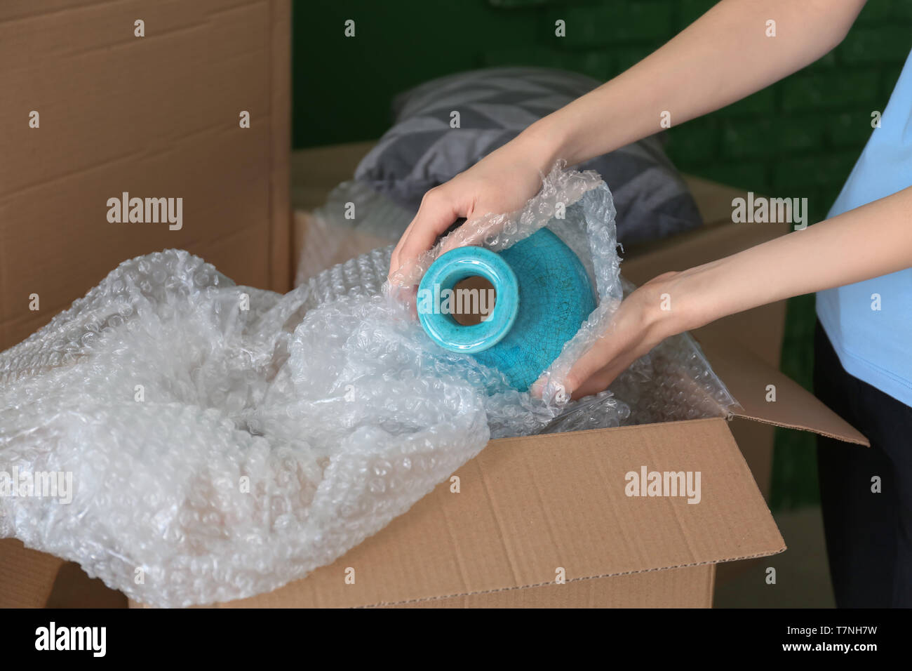 Woman packing carton box indoors. Moving house concept Stock Photo - Alamy