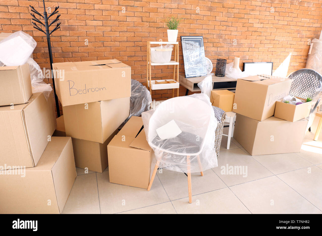 Carton boxes and interior items in room. Moving house concept Stock ...