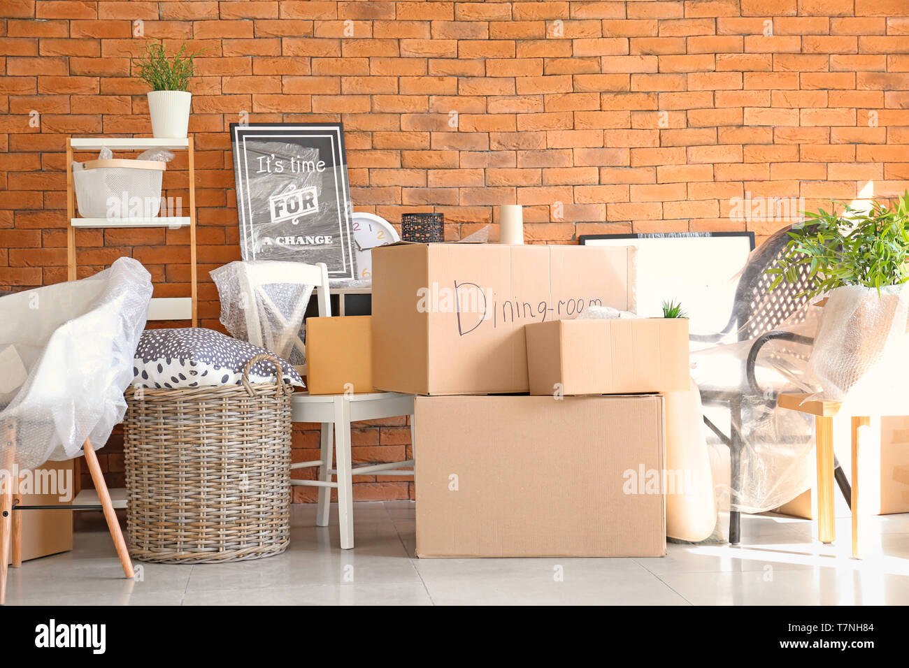 Carton boxes and interior items in room. Moving house concept Stock ...