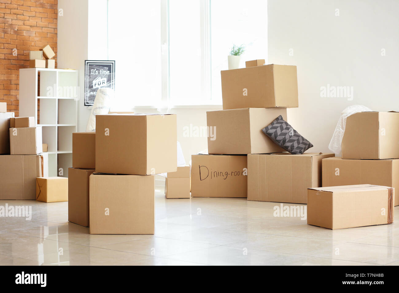 Carton boxes and interior items in room. Moving house concept Stock ...