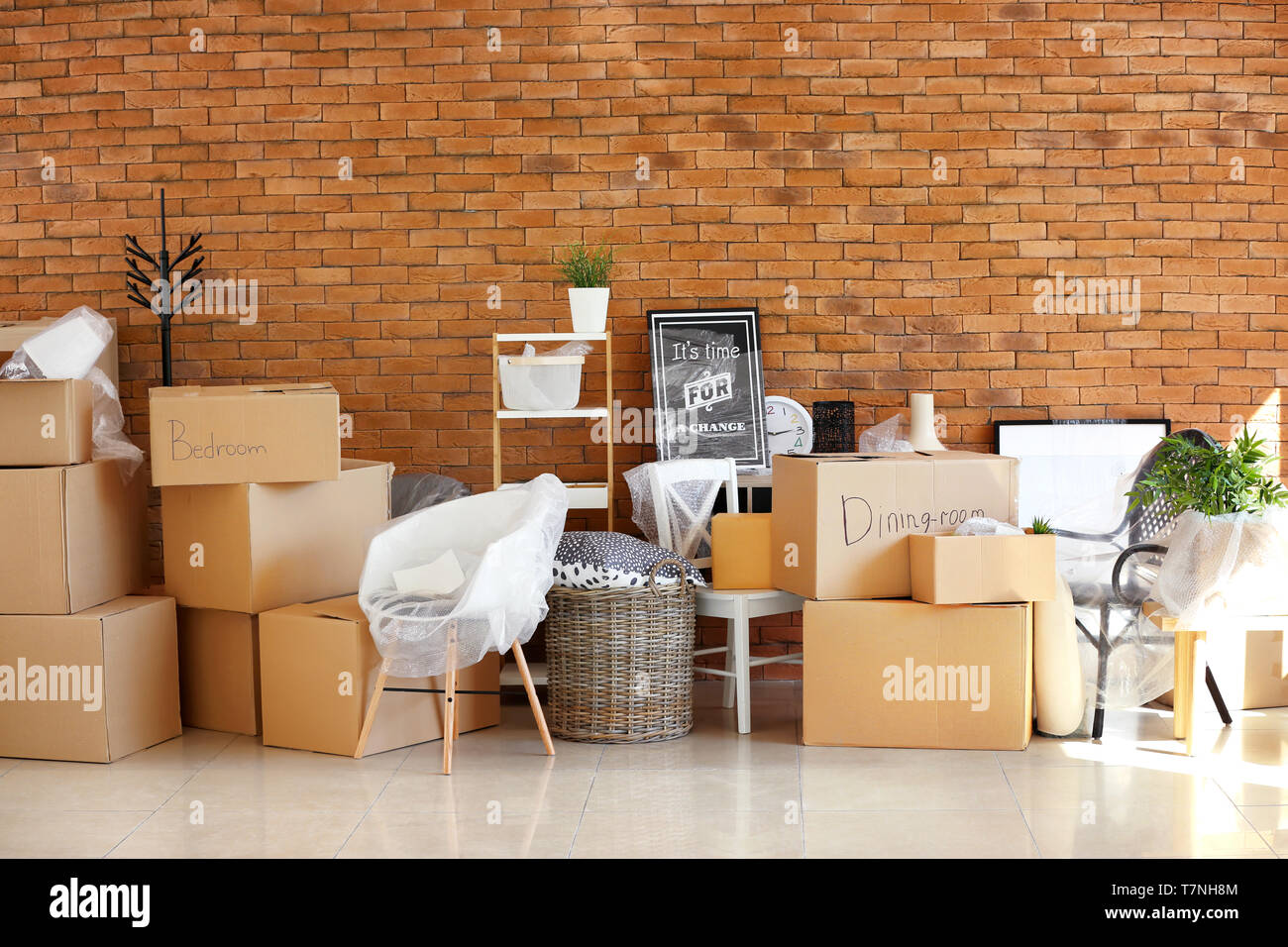Carton boxes and interior items in room. Moving house concept Stock ...