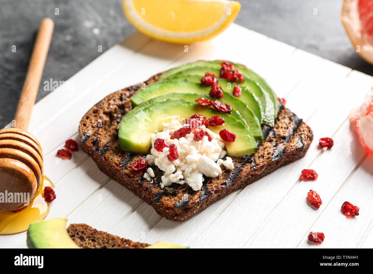 Board with tasty toast on grey background Stock Photo - Alamy
