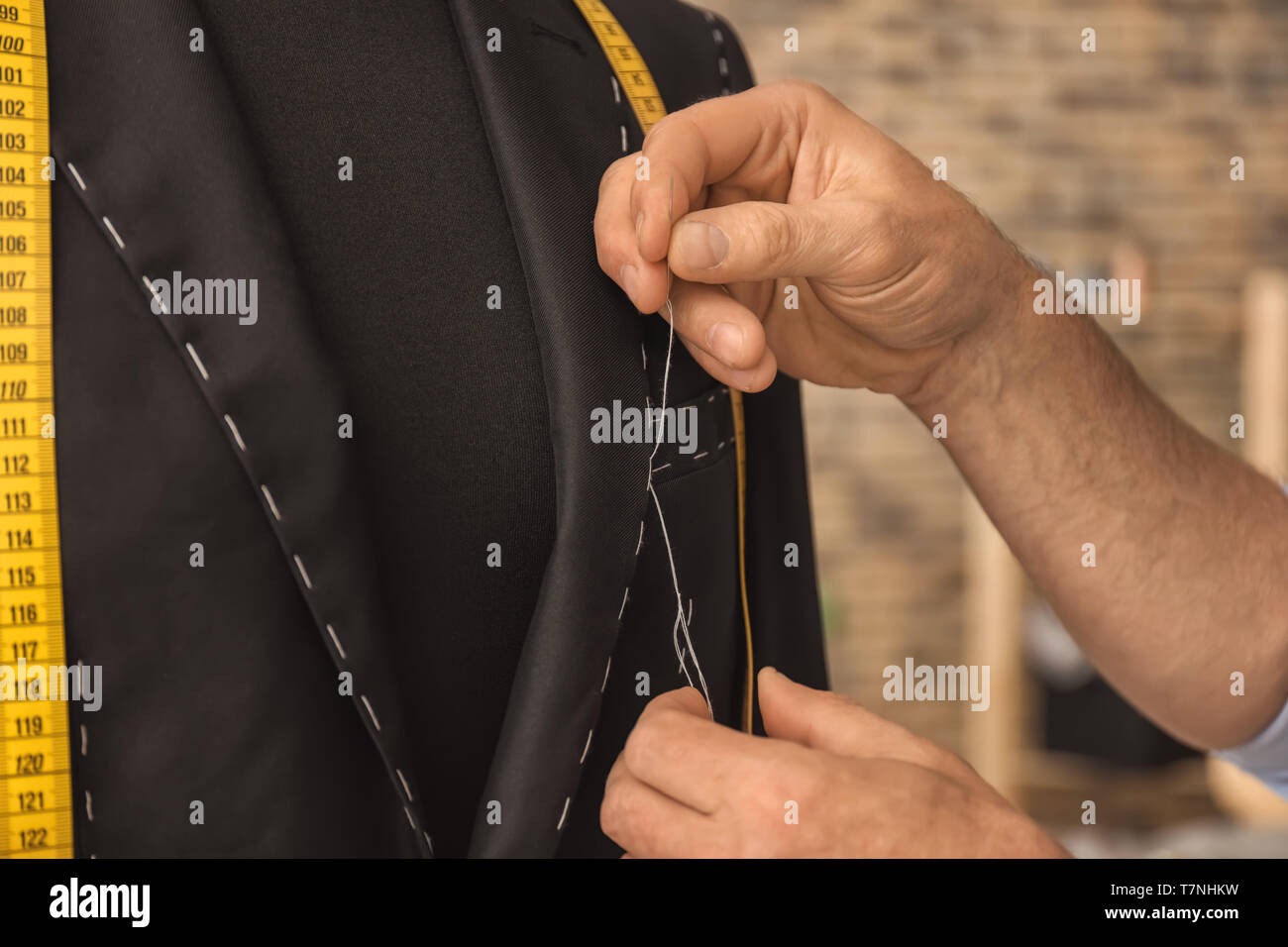 Seamster tailoring jacket on mannequin in atelier Stock Photo - Alamy