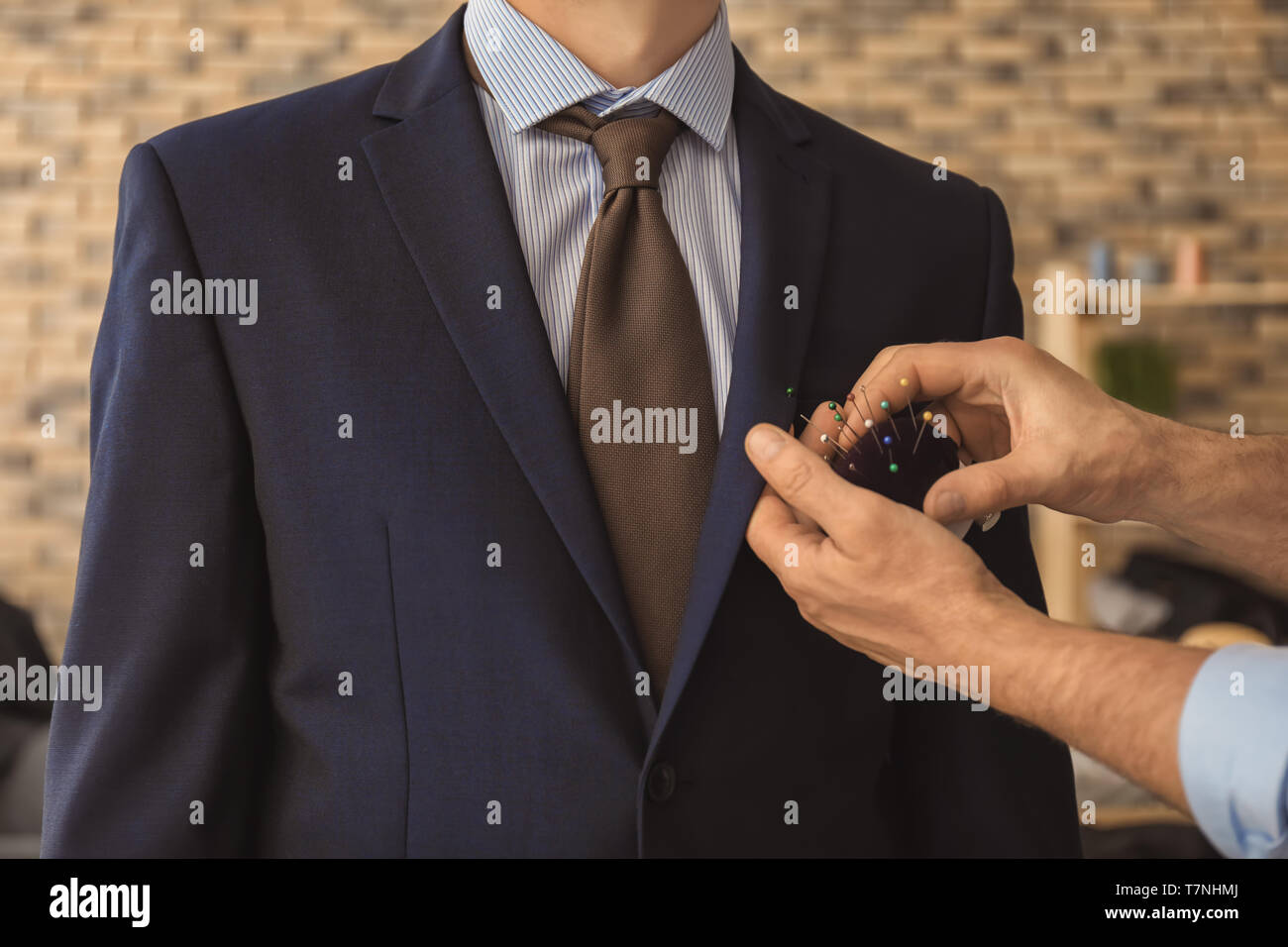 Seamster tailoring suit for client in atelier Stock Photo - Alamy