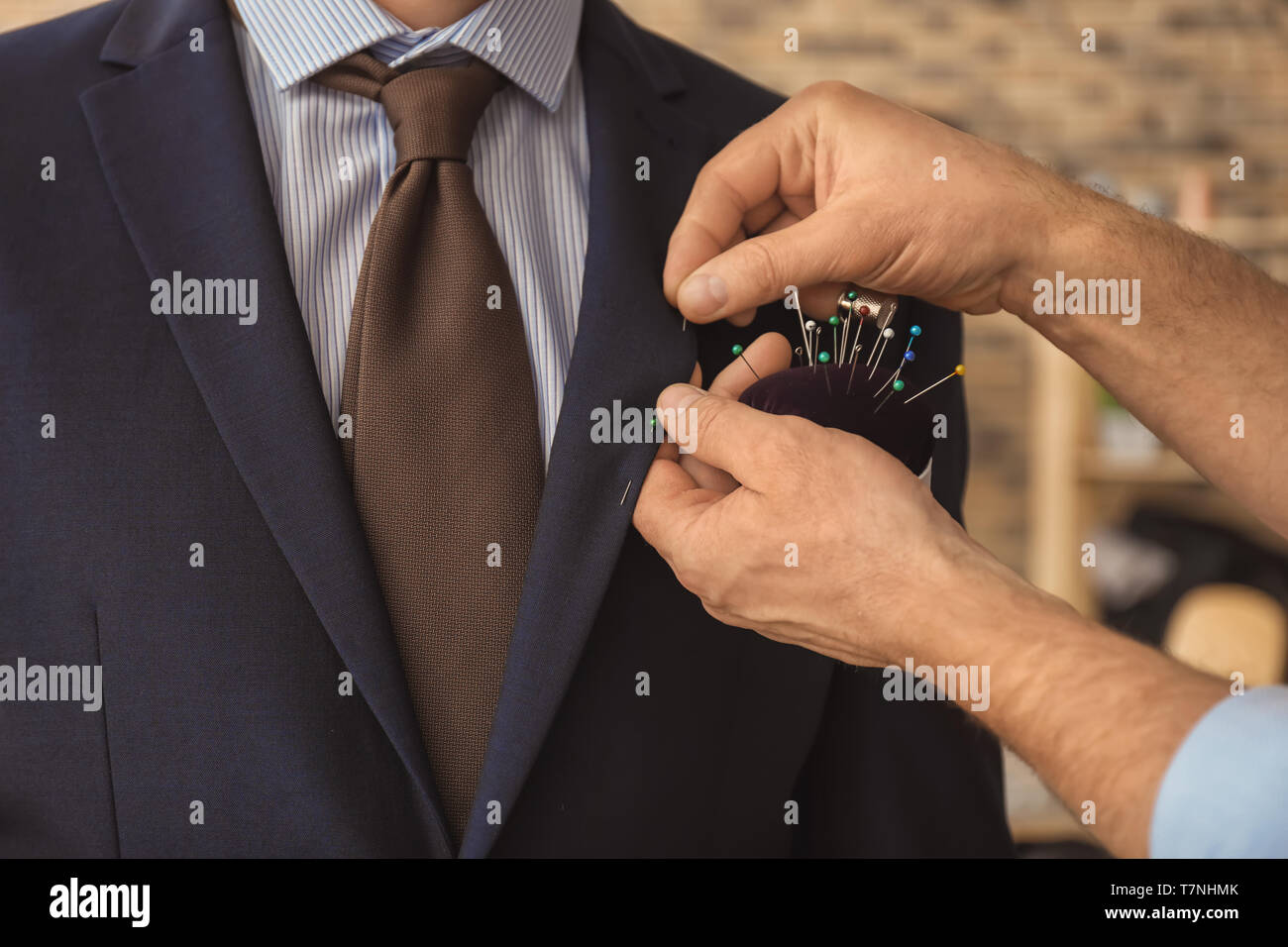 Seamster tailoring suit for client in atelier Stock Photo - Alamy