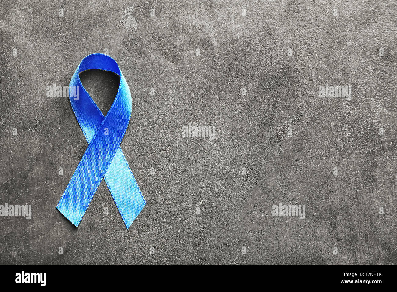 Blue ribbon on grey background. Prostate cancer concept Stock Photo - Alamy