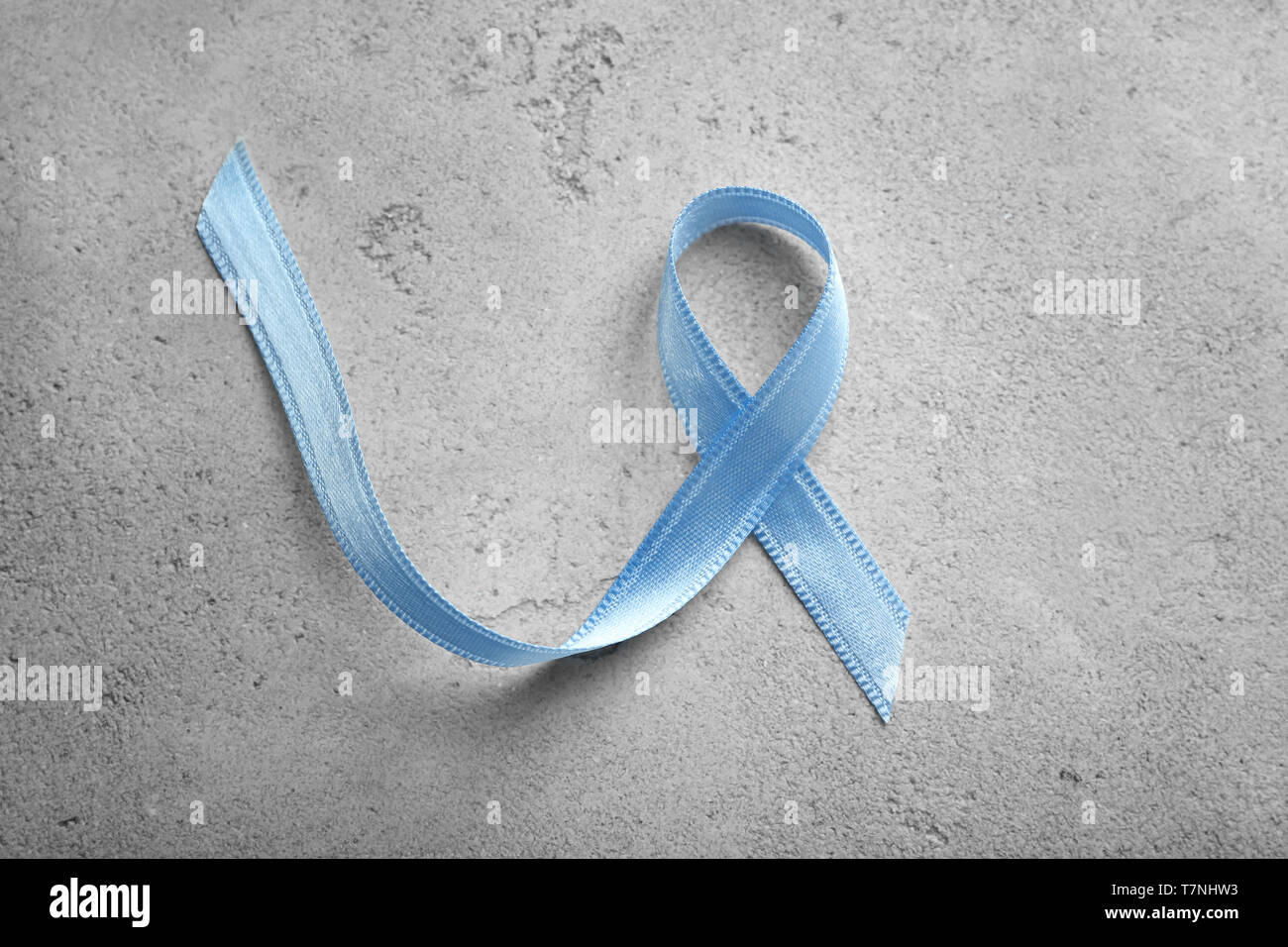 Blue ribbon on grey background. Prostate cancer concept Stock Photo - Alamy