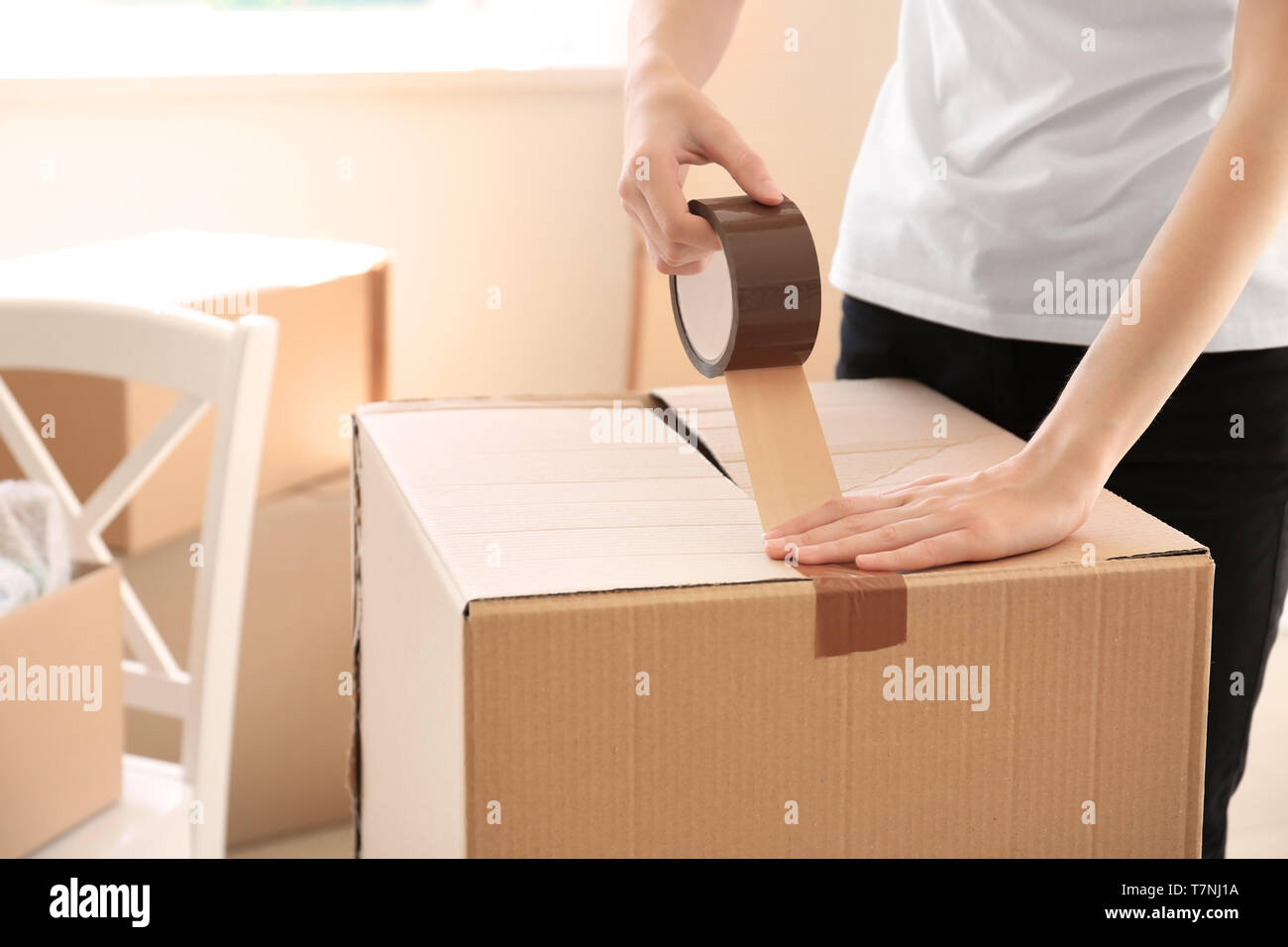 Woman packing carton box hi-res stock photography and images - Alamy
