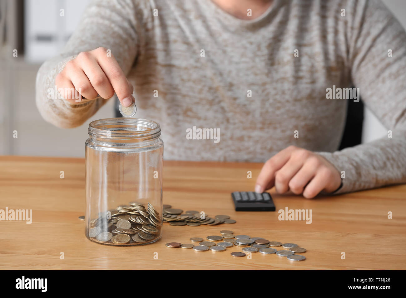 Man counting his savings at table Stock Photo - Alamy