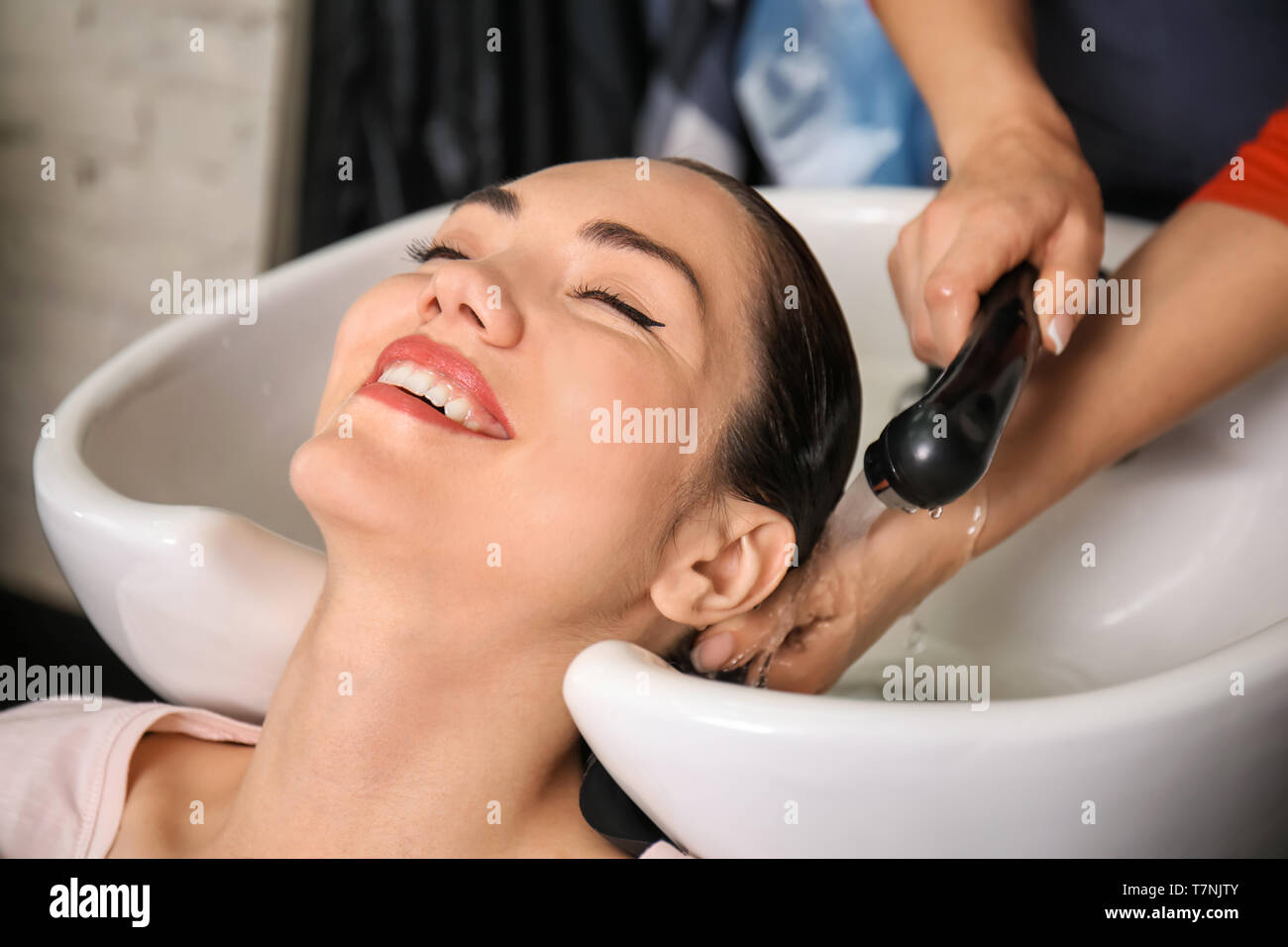 Young woman during washing of hair in beauty salon Stock Photo - Alamy
