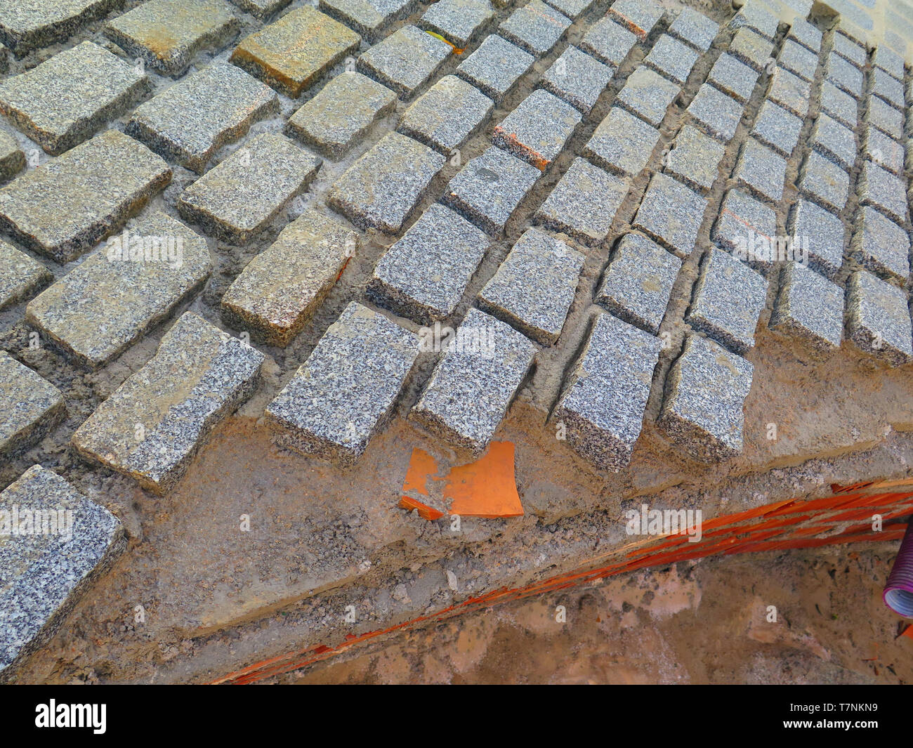 Rectangular paving stones awaiting grouting in village street in ...