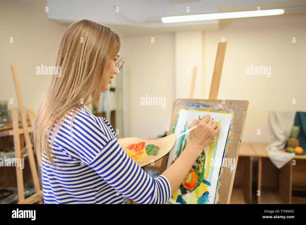 Young female artist painting still life in workshop Stock Photo - Alamy