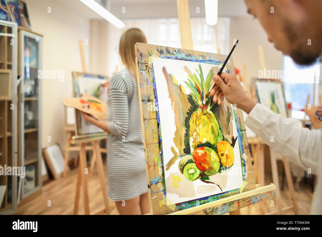 African-American artist painting still life in workshop Stock Photo - Alamy