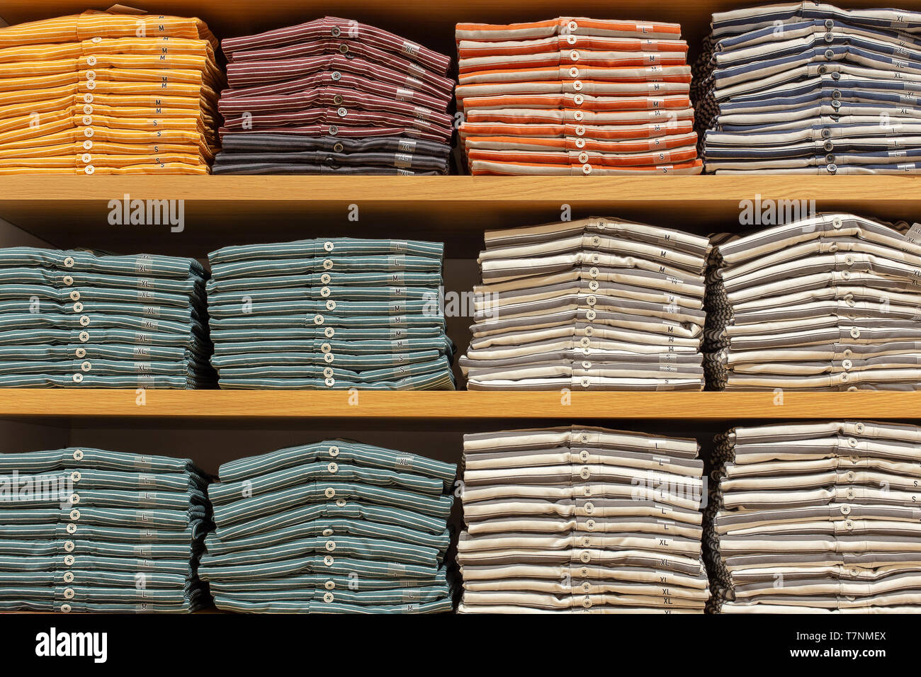Different sizes of clothes in the shop. Close up Stock Photo - Alamy