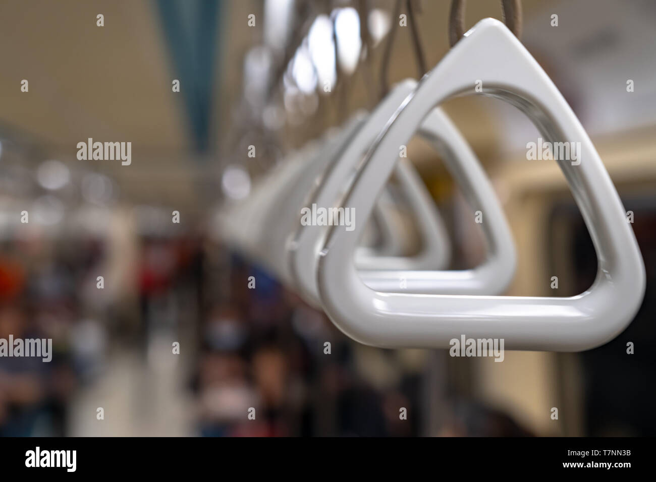 Hold on to the handrail in the train Stock Photo - Alamy