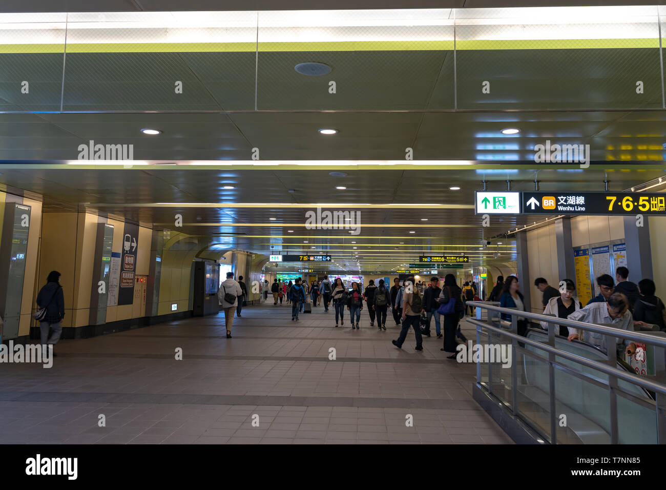 Taipei metro station hall and platform. Subway passengers walk through ...