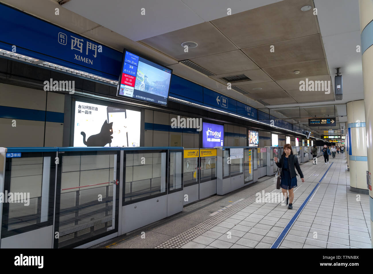 Taipei metro station hall and platform. Subway passengers walk through ...