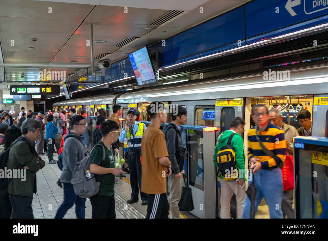 Taipei metro station hall and platform. Subway passengers walk through ...