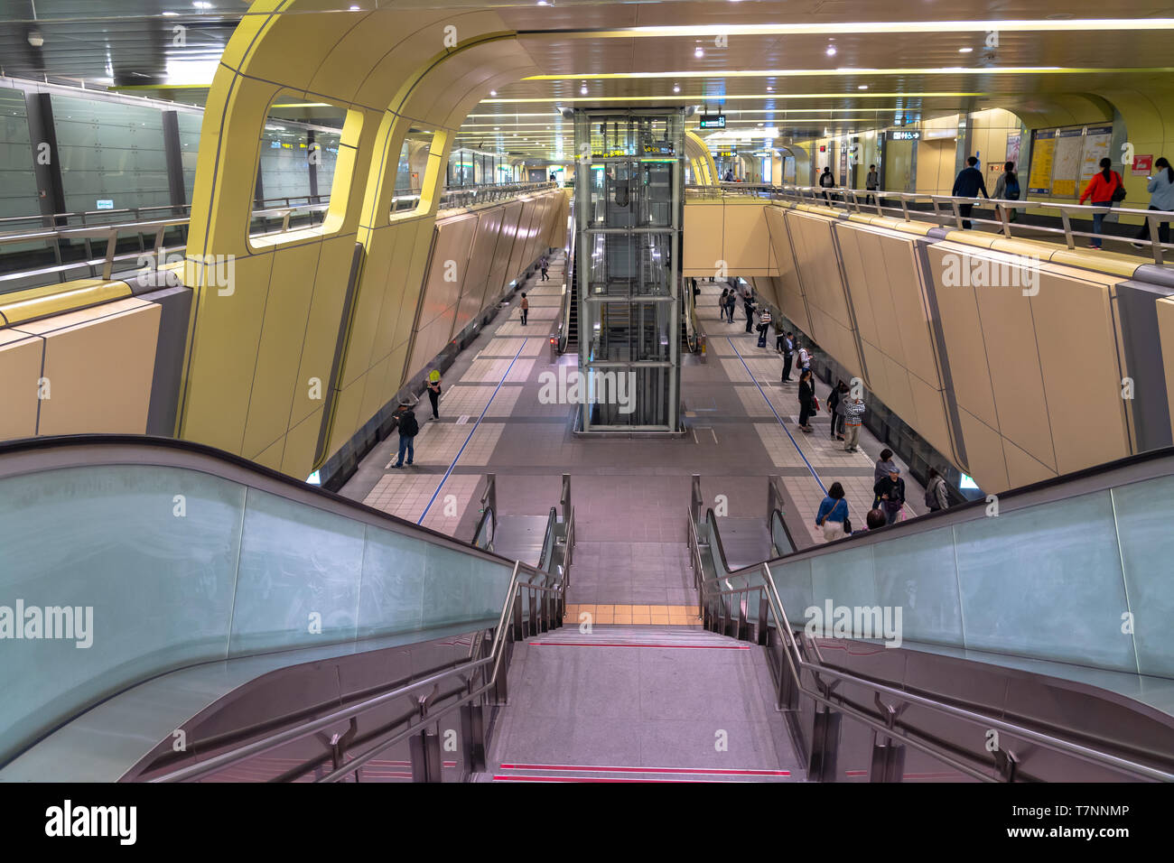 Taipei metro station hall and platform. Subway passengers walk through ...
