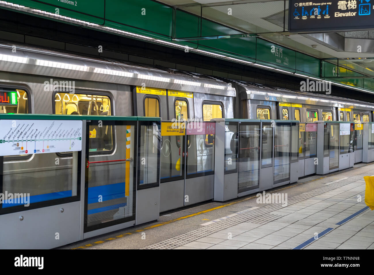 Taipei metro station hall and platform. Subway passengers walk through ...