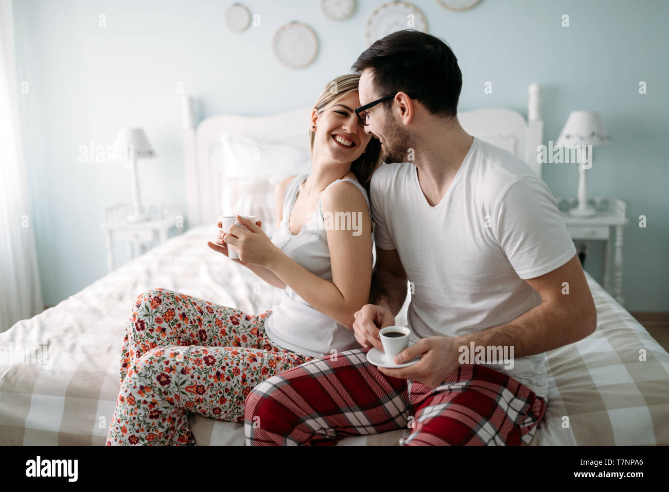 Portrait of young loving couple in bedroom Stock Photo - Alamy