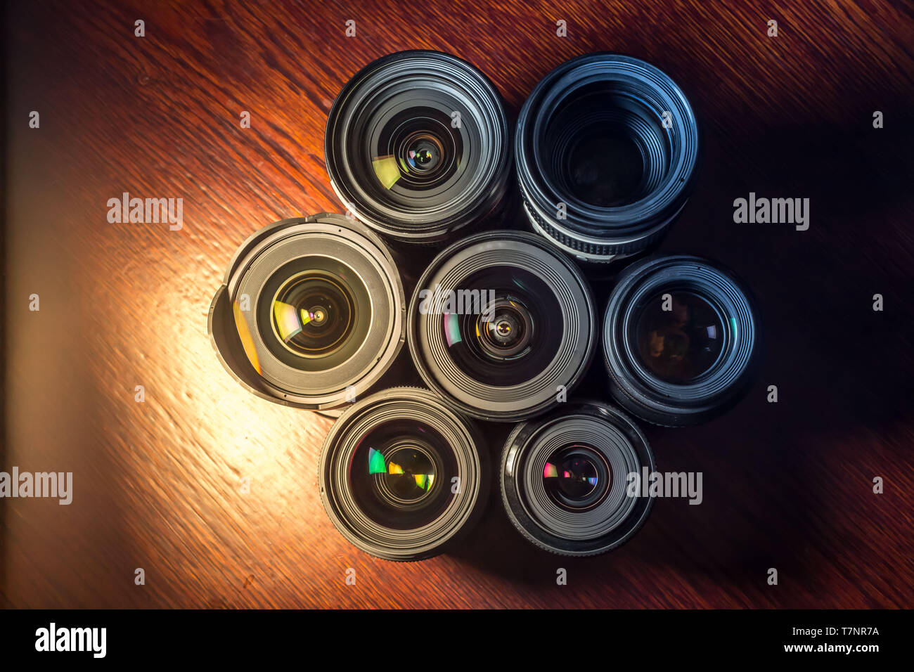 Set of various DSLR lenses with colorful reflections - shot from above ...