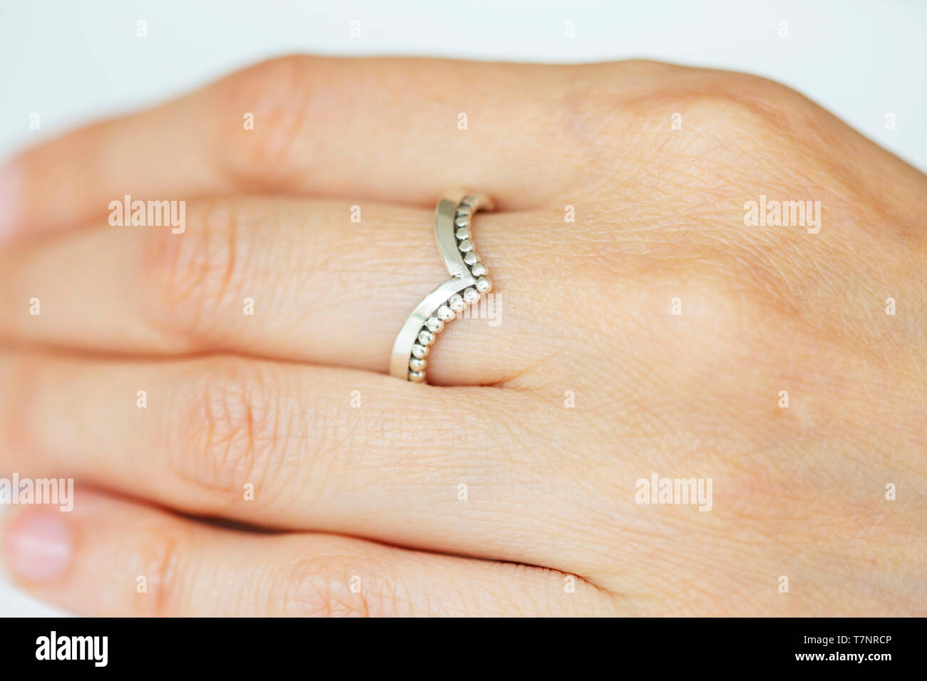 Female hand wearing silver ring Stock Photo - Alamy