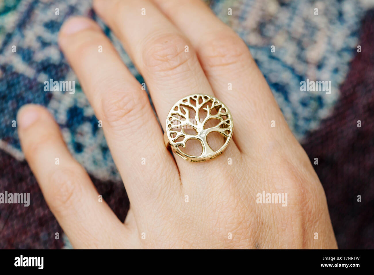 Female hand wearing brass ring in the shape of tree Stock Photo - Alamy