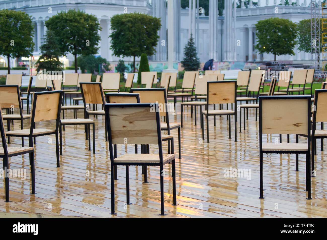 Wooden chairs stand in the rain outside Stock Photo - Alamy
