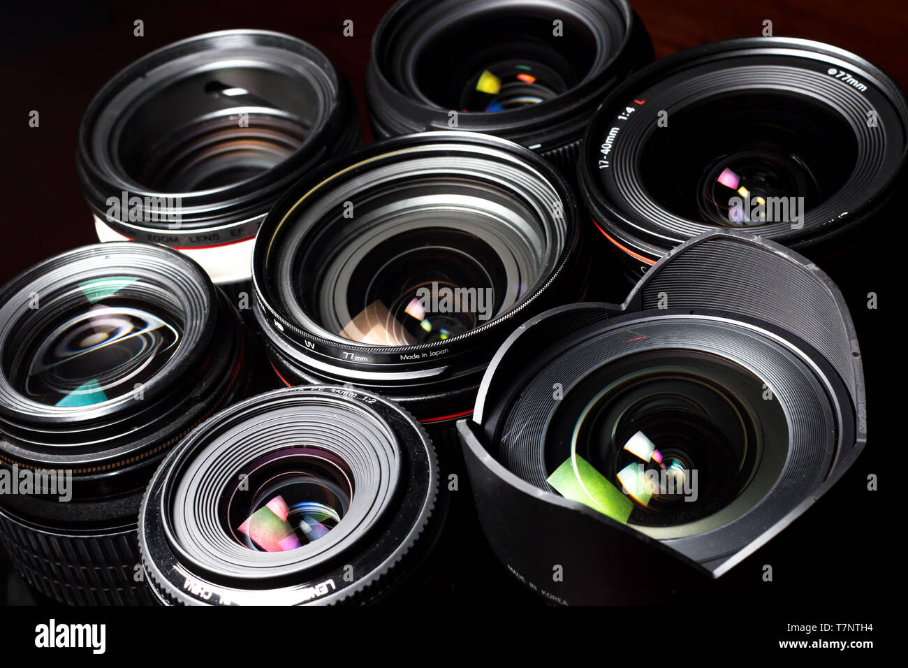 Set of various DSLR lenses with colorful reflections - shot from above ...
