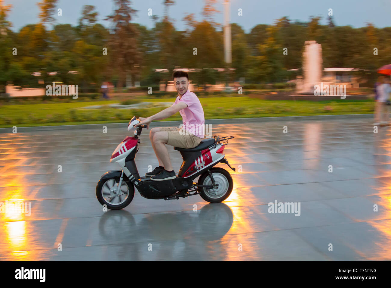 Old man riding scooter moped hi-res stock photography and images - Alamy
