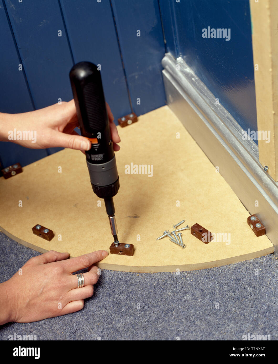 Hands using powered screw driver Stock Photo - Alamy