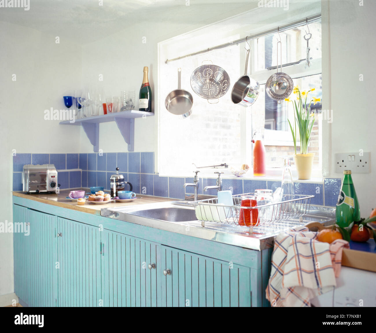 Tongue+groove panelled units in renovated kitchen Stock Photo - Alamy