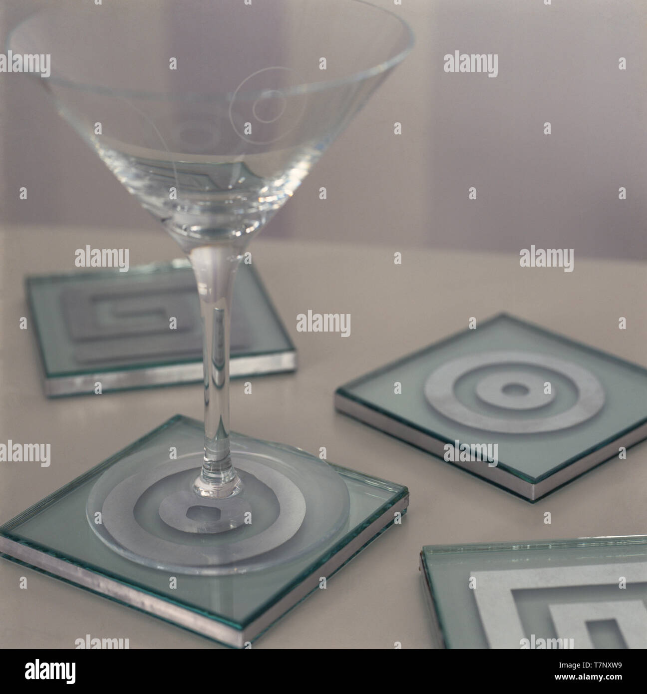 Cocktail glass with glass coasters Stock Photo - Alamy