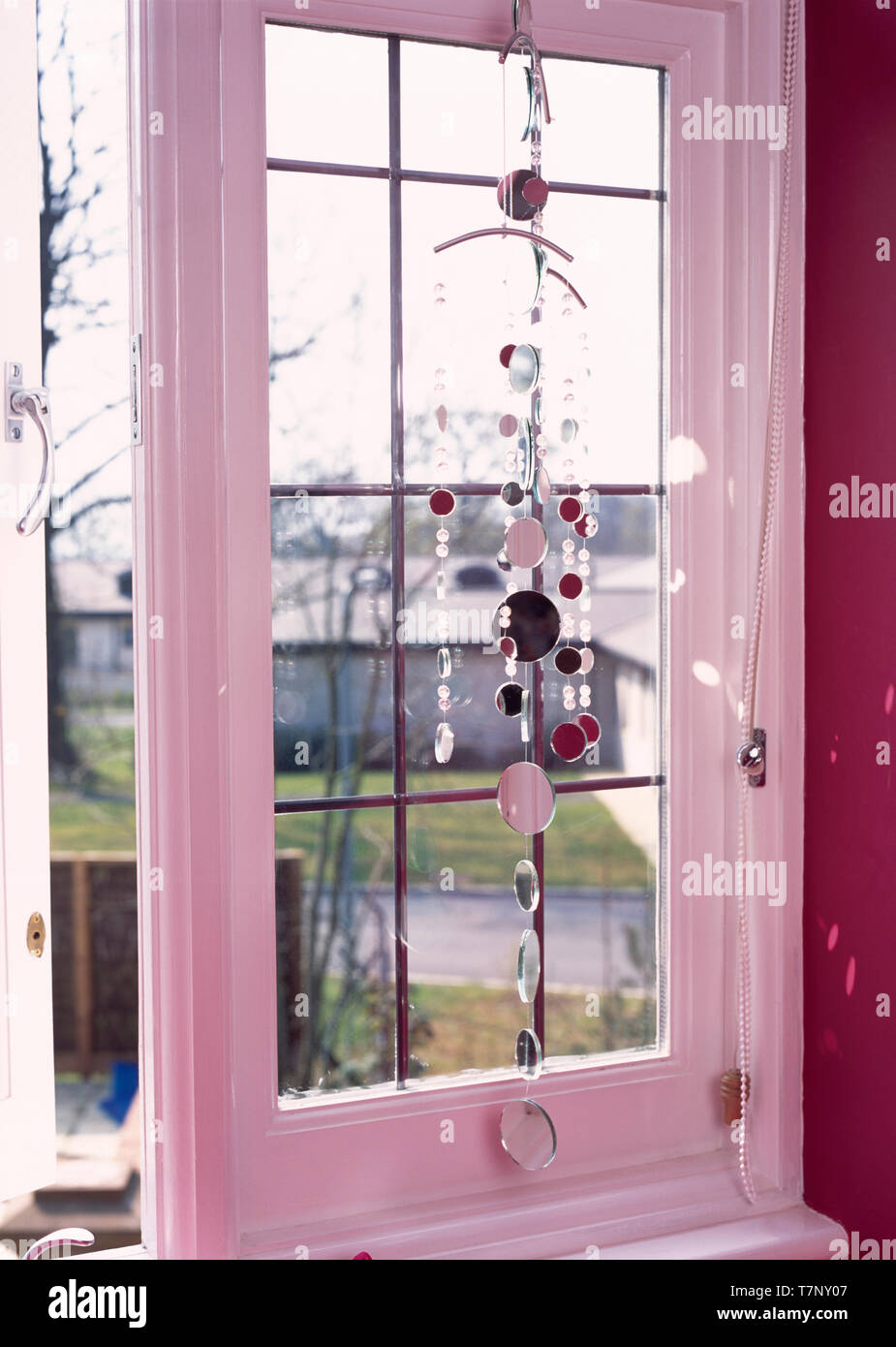 Wind chimes on newly renovated window Stock Photo - Alamy