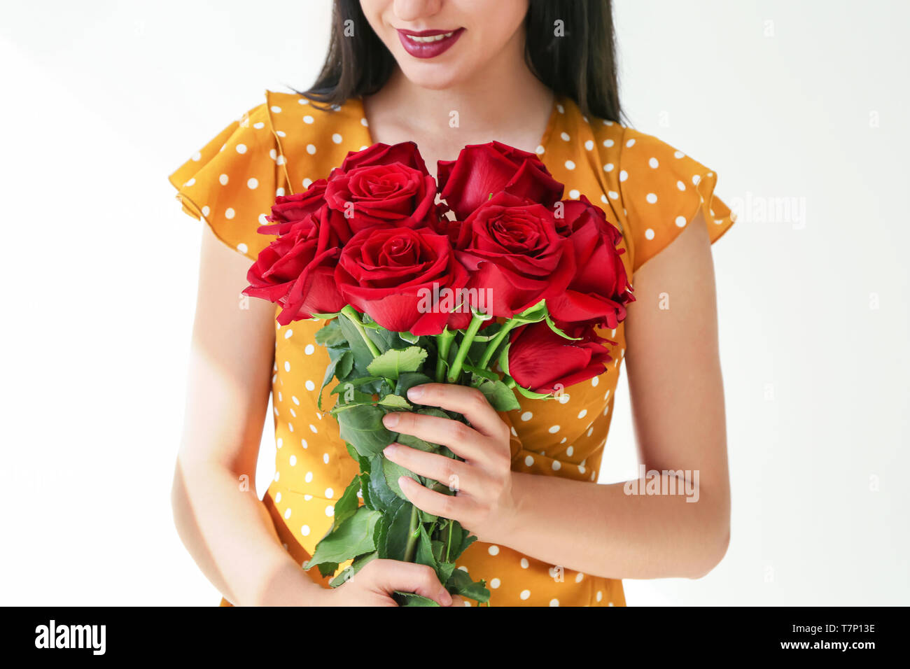 Woman holding beautiful roses on white background Stock Photo - Alamy