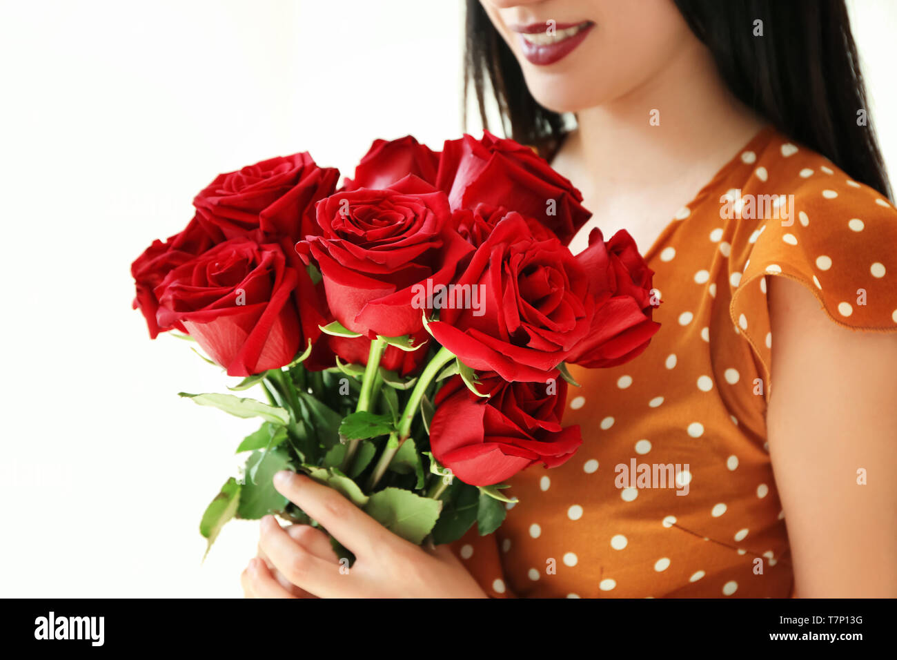 Woman holding beautiful roses on white background Stock Photo - Alamy
